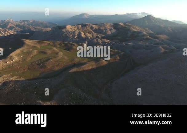 Treeless desert landscape spreads across barren plains and dry hills ...
