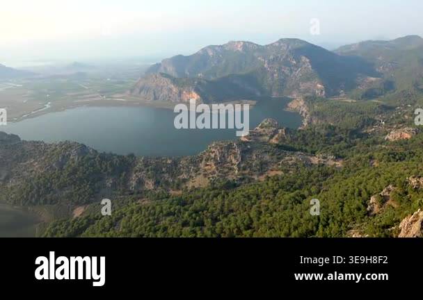 Aerial coastal view shows shoreline relief, blue water, and bright ...