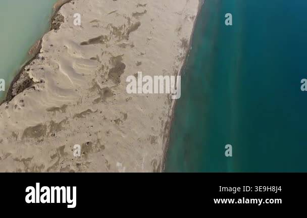 Aerial view shows sand barrier between sea and coastal lagoon beneath ...