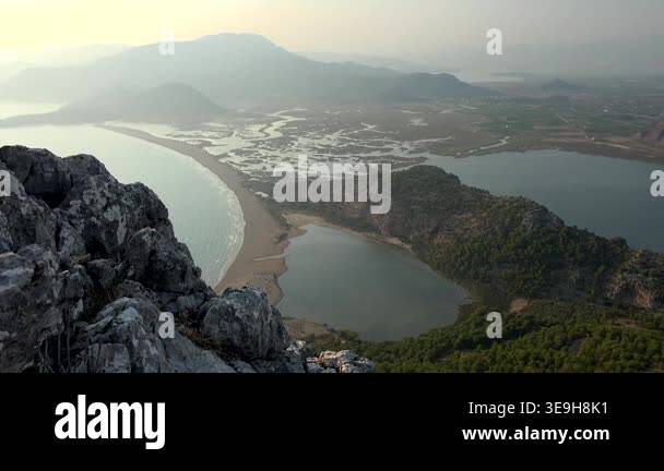 Aerial coastal view shows shoreline relief, blue water, and bright ...