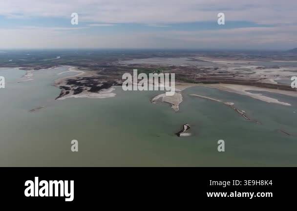 Aerial view shows sand barrier between sea and coastal lagoon beneath ...