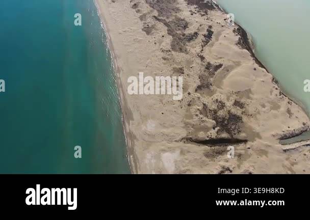 Aerial view shows sand barrier between sea and coastal lagoon beneath ...