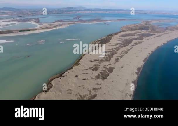 Aerial view shows sand barrier between sea and coastal lagoon beneath ...