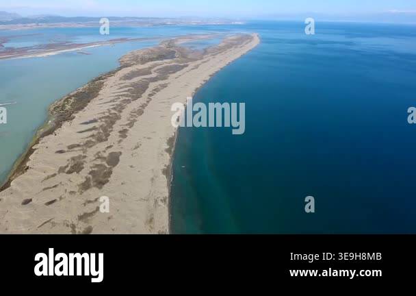 Aerial view shows sand barrier between sea and coastal lagoon beneath ...