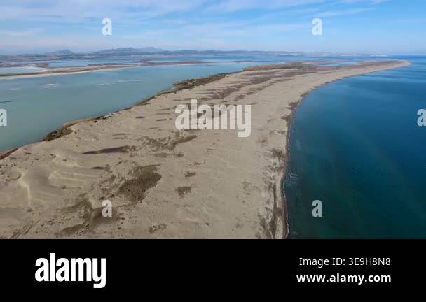 Aerial view shows sand barrier between sea and coastal lagoon beneath ...
