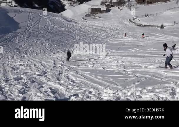 People sliding on traditional lazboard during snowy winter festival in ...