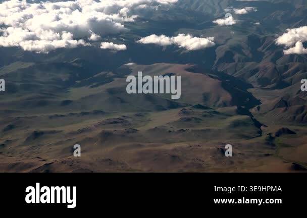 Aerial view of treeless hills and mountains across southern Peru ...