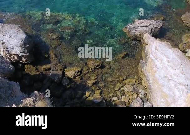 Aerial drone view of rocky coastline with cove and peninsula along a ...