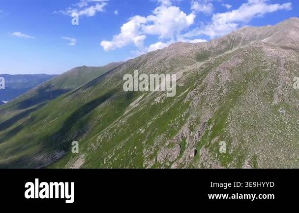Aerial view of U shaped valley with stream and green meadows in the ...