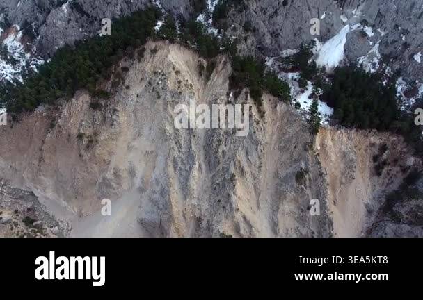 Aerial view of massive landslide tearing through forested mountain ...