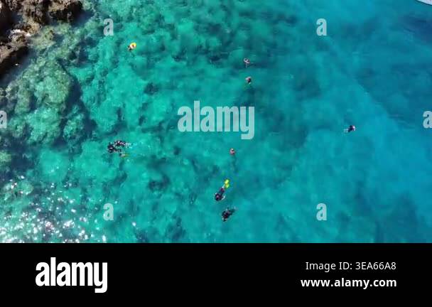 Aerial scuba diving training above rocky reef shows students and ...