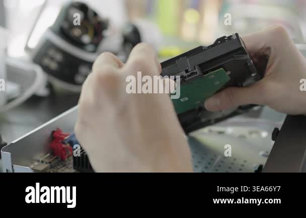 Close-up, Repairing or installing hard disk into a security camera ...