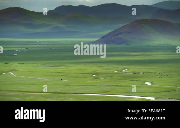 Open steppe and valley plain stretch wide beneath calm daylight across ...