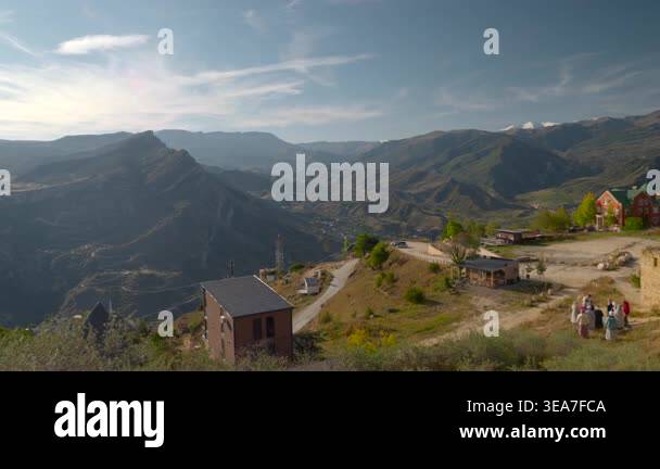 Mountain Village Overlook With Hikers, Rustic Brick House Perched Above ...