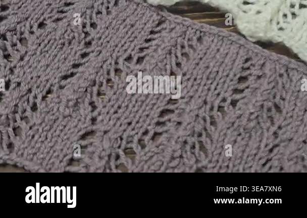 A raised openwork pattern knitted with colored yarn on a wooden ...
