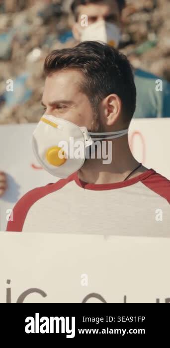 A diverse group at a lively protest wearing masks, advocating for ...