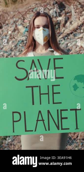 A young activist with a vibrant sign urging for essential planet ...