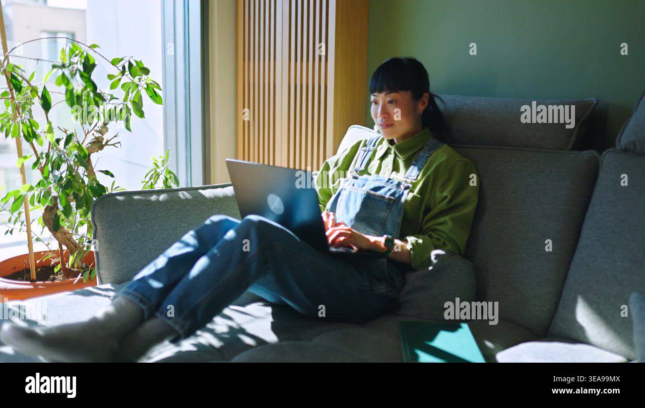 Woman using laptop at home Stock Video Footage - Alamy