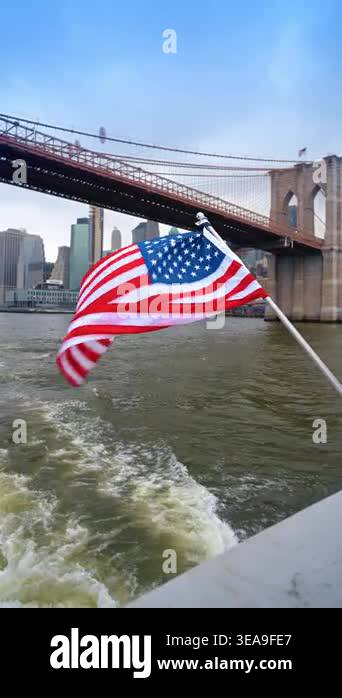 United States flag on ferry with Brooklyn Bridge background. Waving ...
