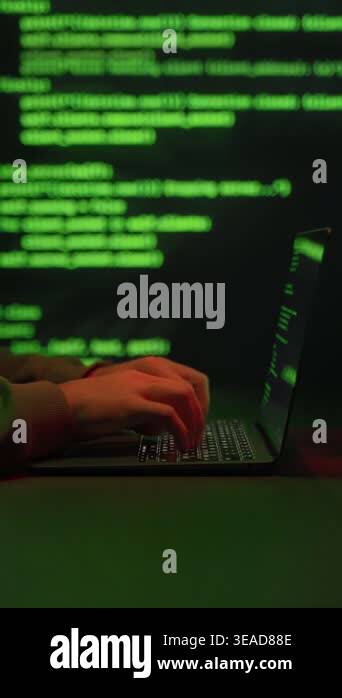 Close up of hacker hands opening a laptop and typing in dark ...