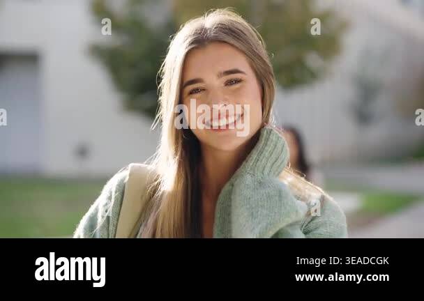 Portrait of a gorgeous young female student with a backpack smiling and ...