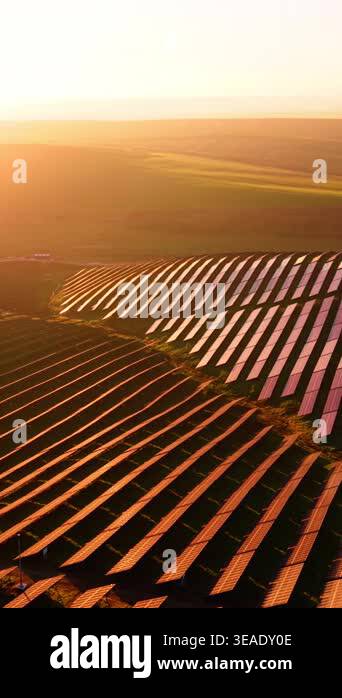 Panoramic aerial view of solar panel arrays covering rolling hills ...