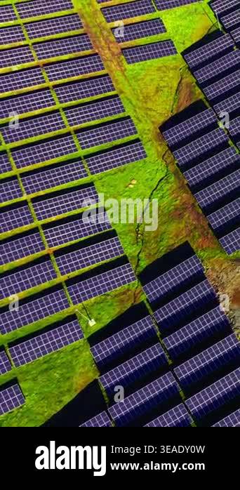 Photovoltaic panels separated by a natural green gully and small stream ...