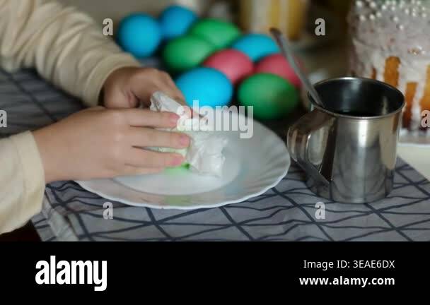 The process of dyeing an Easter egg pink. The background features ...