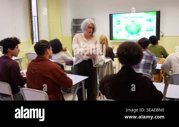 The teacher is handing out the exams in ecology lesson. Students ...