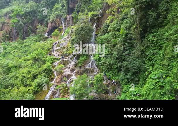 Aerial view of the path to Tumpak Sewu waterfall through many smaller ...