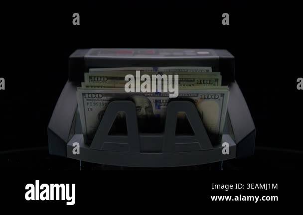 Close-up of an automatic money counter processing stacks of one hundred ...