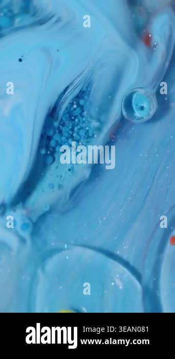 Vertical video. Blue bubbles. Bokeh oil. Defocused yellow orange color ...