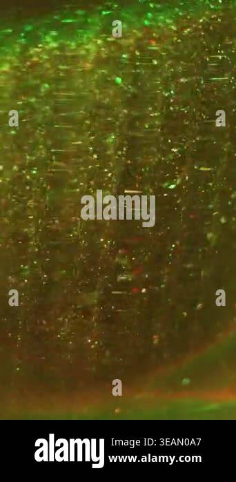 Vertical video. Color light. Defocused glitter rainbow. Warm yellow ...