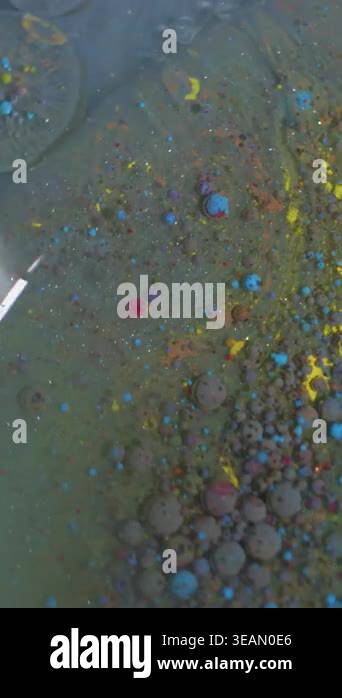 Vertical video. Color oil mix. Bubble art. Defocused yellow blue purple ...