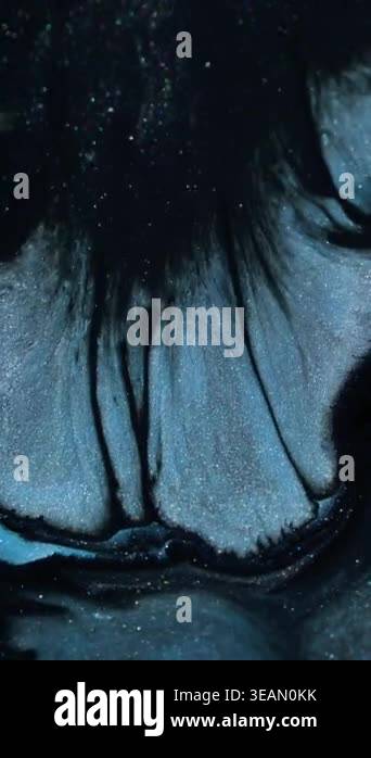Vertical video. Ink splatter. Glitter wave. Defocused blue color ...