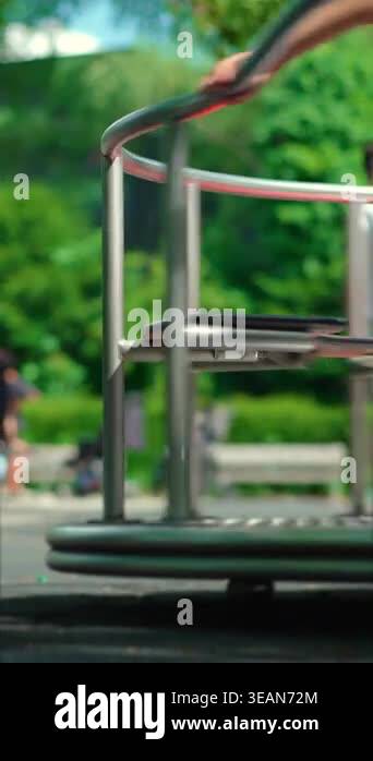 Roundabout in continuous rotation with blurred figure and playground ...
