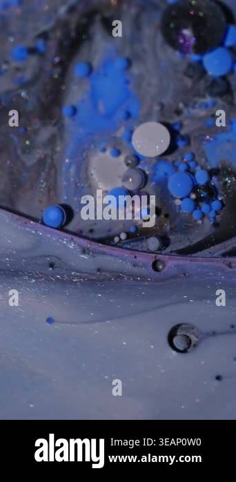 Vertical video. Bubble water. Ink oil mix. Blur blue purple golden ...