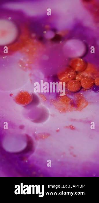 Vertical video. Color bubbles. Oil fluid. Blur orange purple blue paint ...