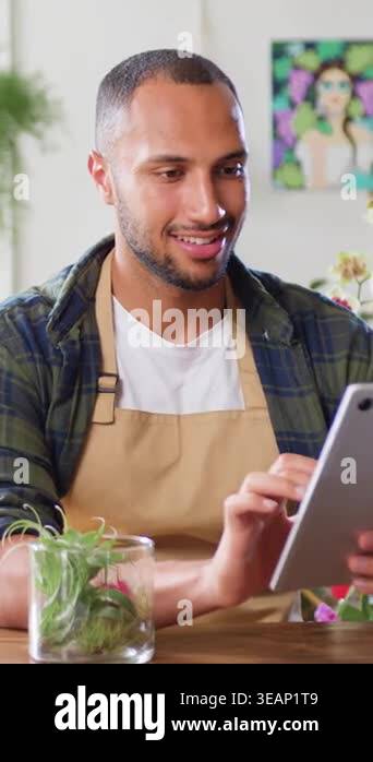 Portrait of african american man using digital tablet computer sitting ...