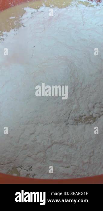 The process of making homemade baked goods: adding white flour to a ...