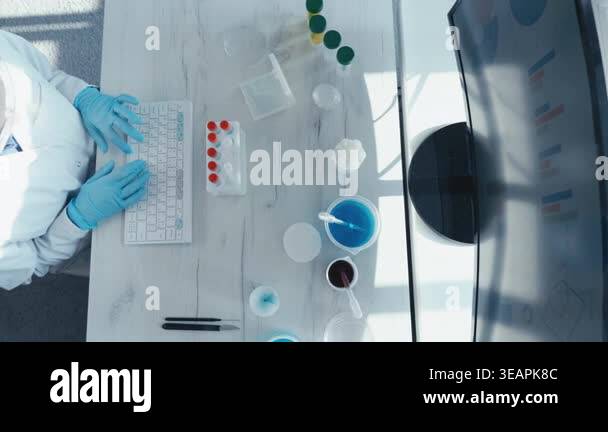 A laboratory professional analyzes data on a computer while surrounded ...