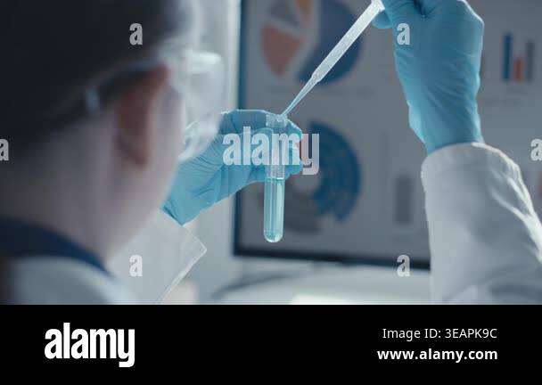 A laboratory professional analyzes a blue solution in a test tube ...