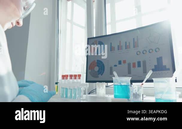 A woman researcher works in a bright laboratory, surrounded by ...