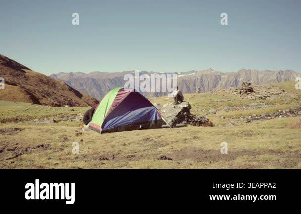 This features a stunning mountain landscape with a colorful tent ...