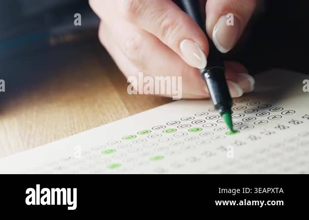 Close-up of answering test questions representing data evaluation and ...