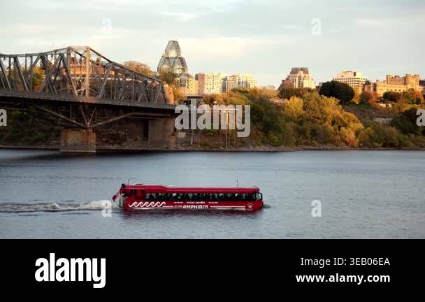 Ottawa, Canada - October 10, 2025: Red amphibious tour bus sailing on ...