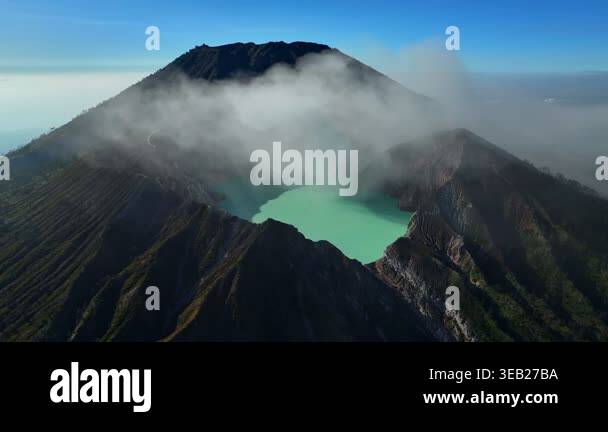 Aerial view drone orbit around to reveal Kawah Ijen volcano crater ...