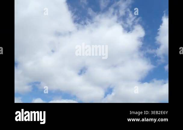 A small quadcopter drone maneuvering through white clouds against a ...