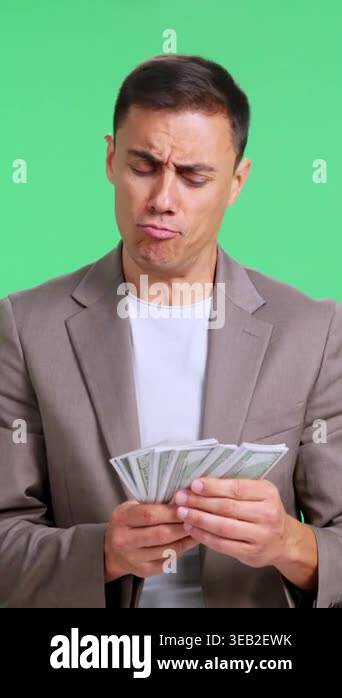 Dissatisfied businessman counting cash money and looking disappointed ...