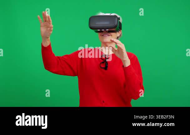 Modern older woman enjoying an immersive experience with virtual ...